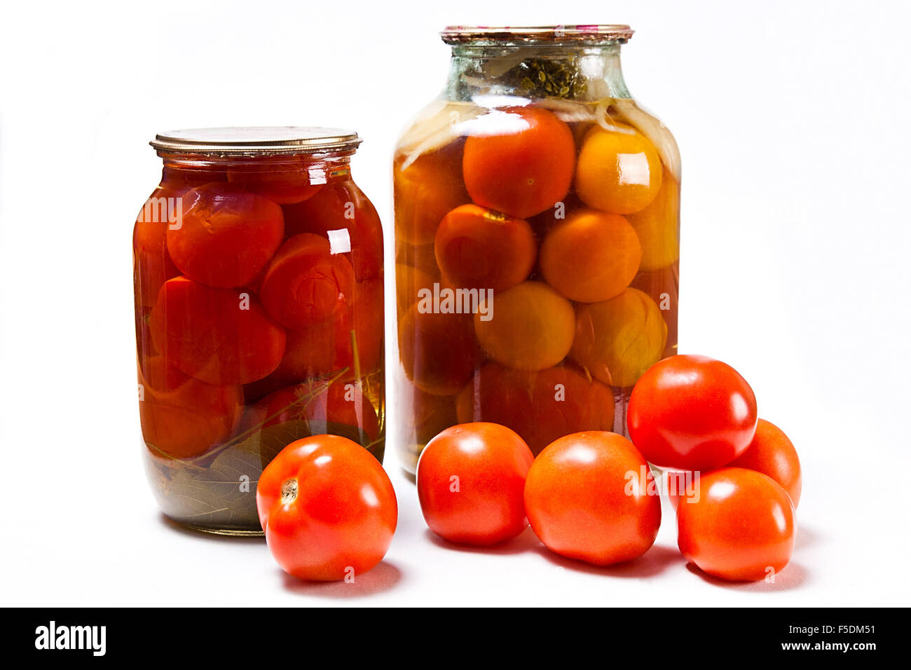 Fresh and canned red tomatoes in glass jar isolated on white background ...