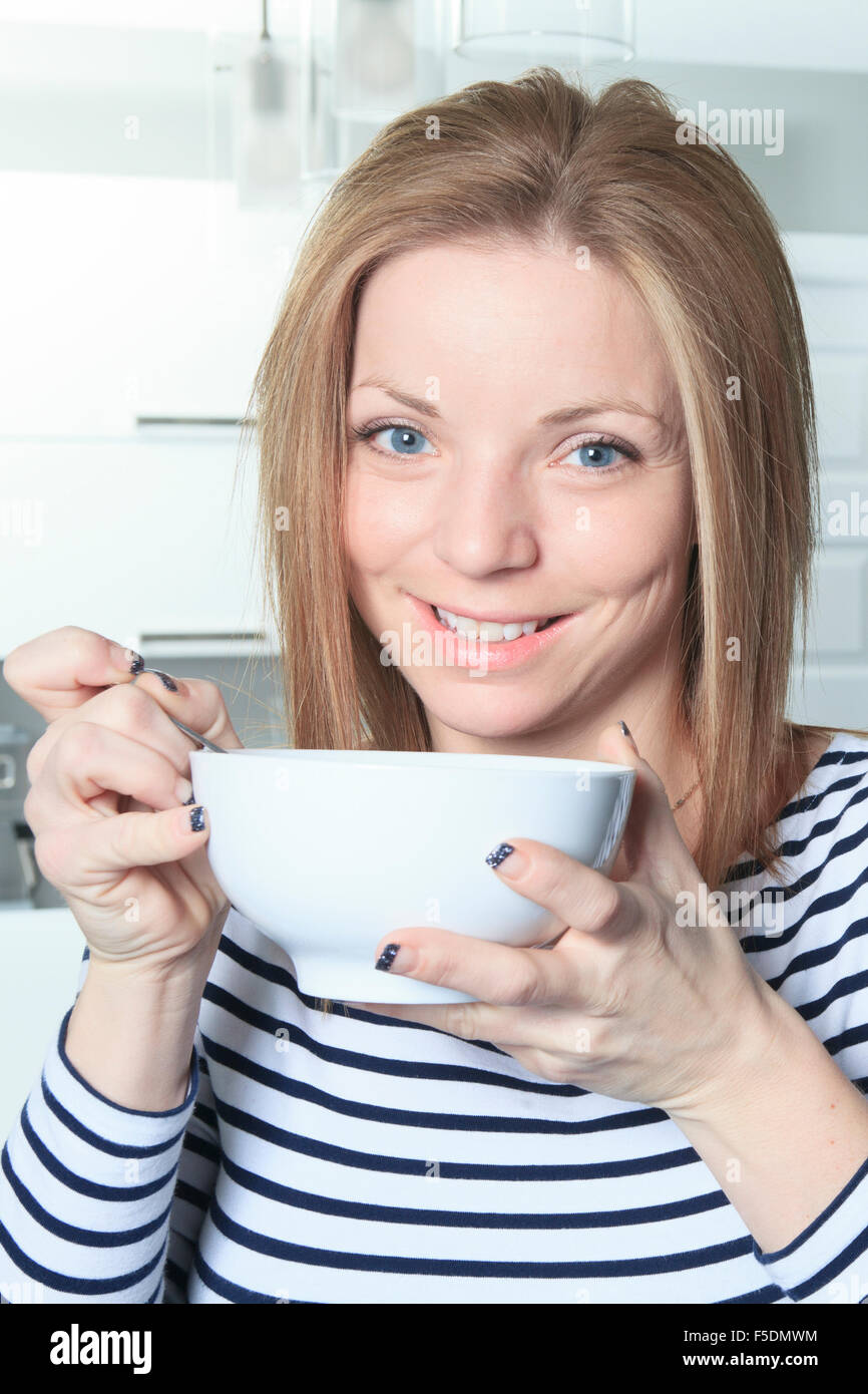 Jolly woman having breakfast at home Stock Photo - Alamy