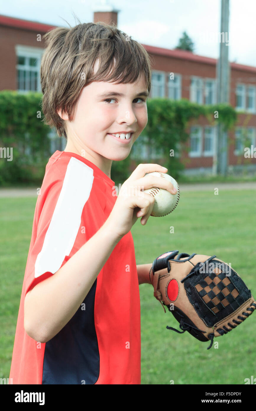 Portrait of a young baseball player in a field Stock Photo - Alamy