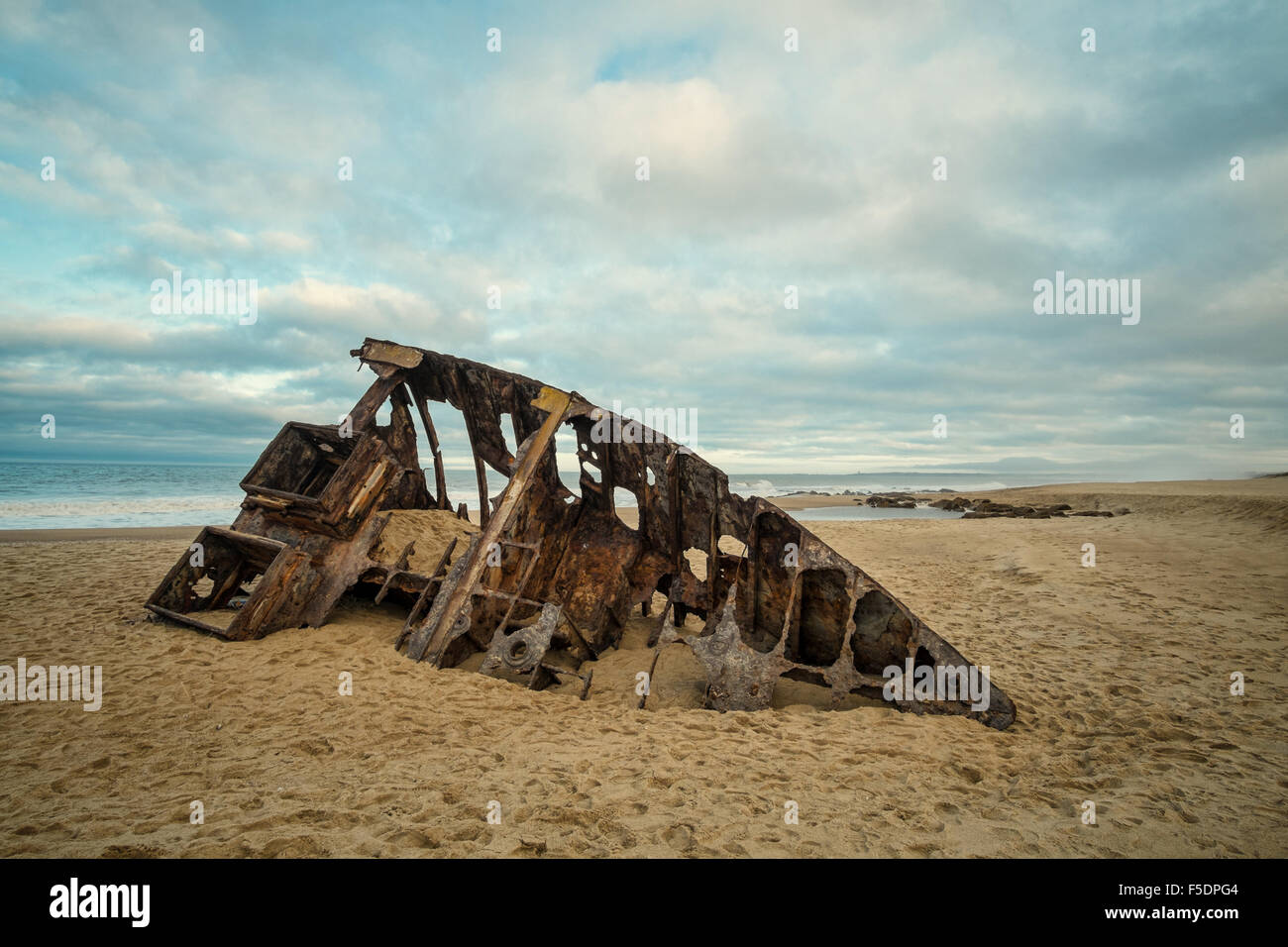 Remains of a ship rotting on a sand beach Stock Photo - Alamy