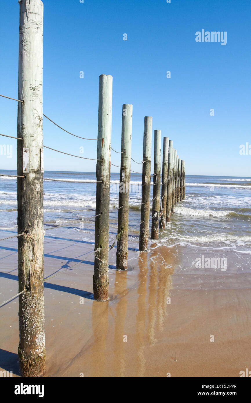 Wooden Post Fence into the Ocean Stock Photo - Alamy