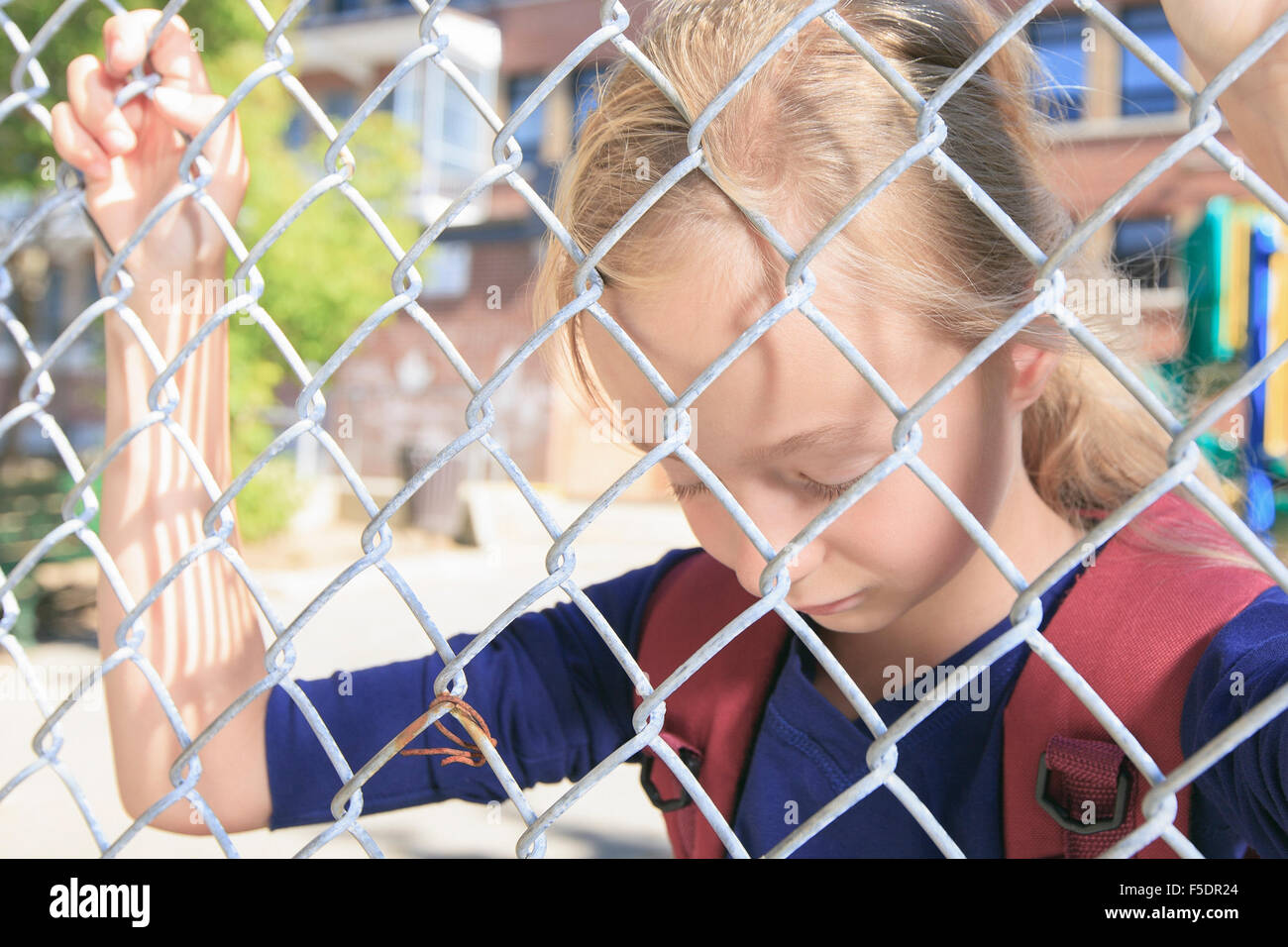 Sad fence girl Stock Photo - Alamy