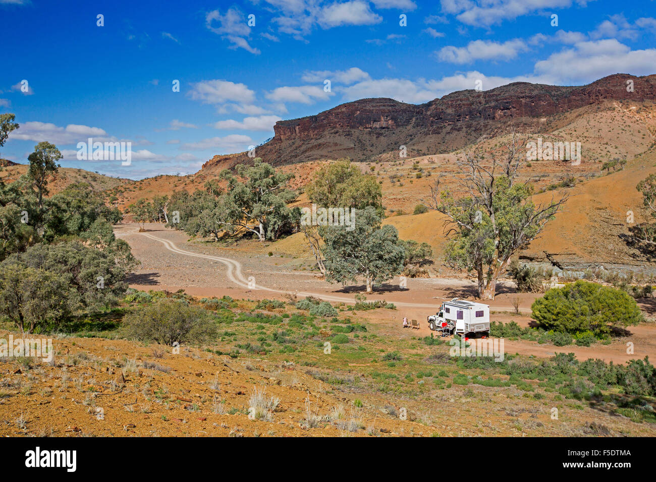 Spectacular outback landscape with motorhome beside track at base of ...