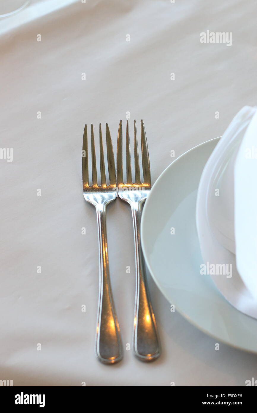 Two forks on a table Stock Photo - Alamy