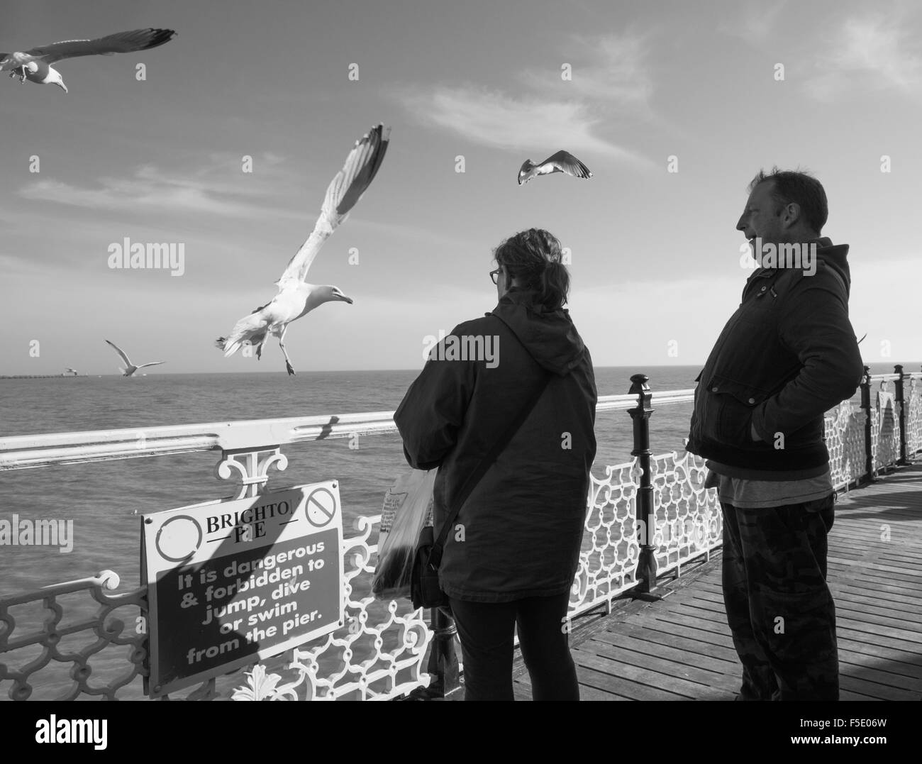 People enjoying Brighton pier in Spring sunshine Stock Photo - Alamy
