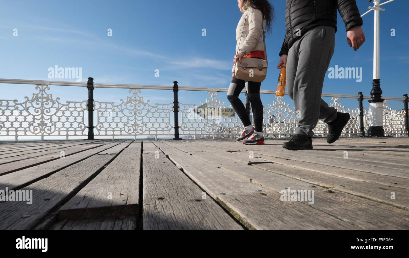 People enjoying Brighton pier in Spring sunshine Stock Photo - Alamy