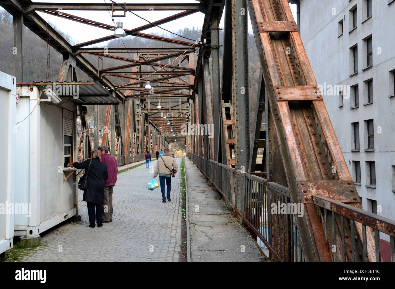 People crossing old Yugoslav weathered metal bridge checkpoint in ...