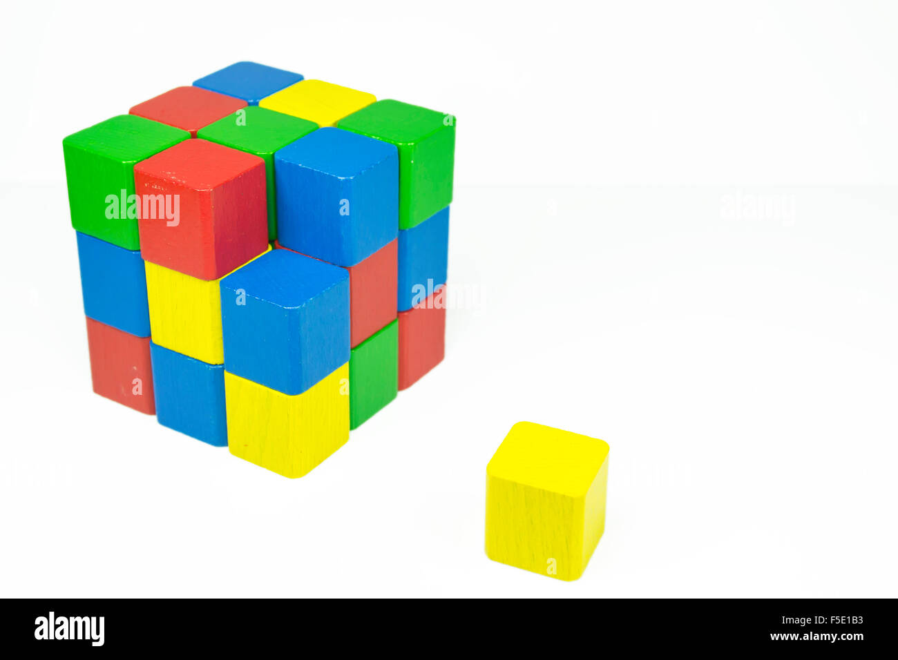Cube made from smaller colored wooden cubes with one detached ...