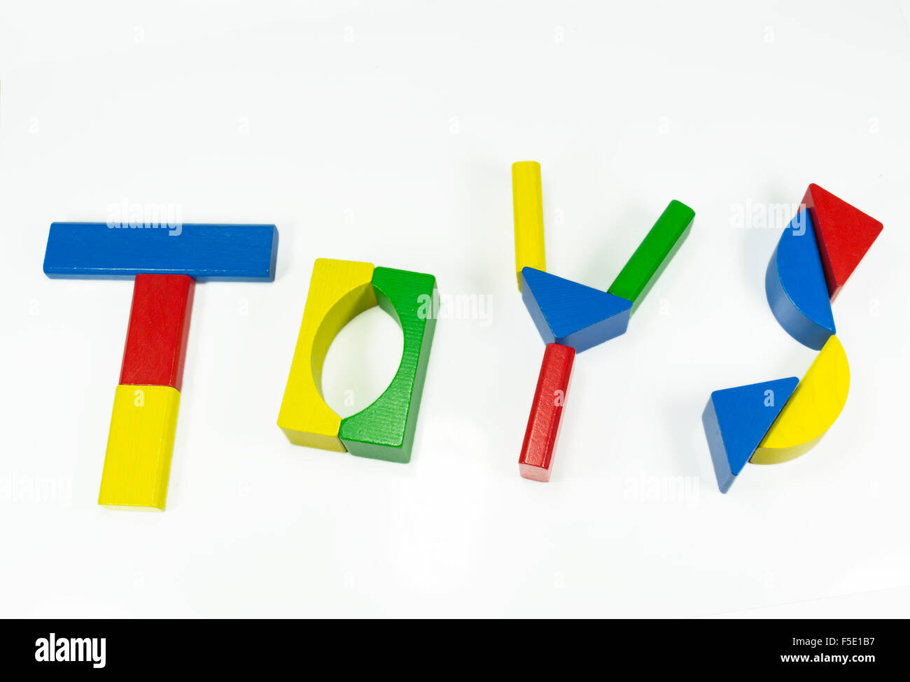 The word "toys" written using colored wooden pieces , isolated on white ...