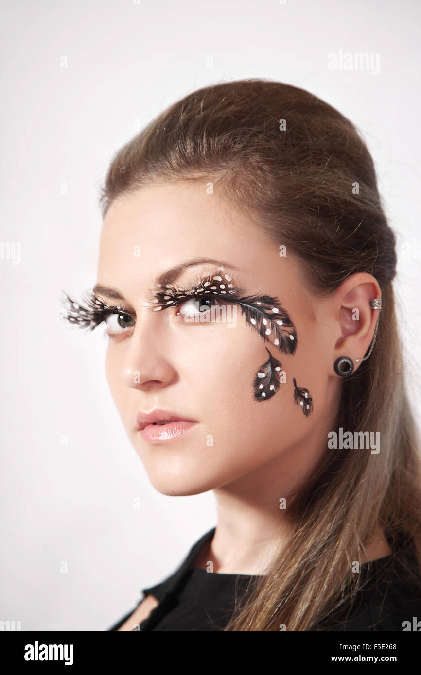 Beautiful woman with big eyelashes and face-art Stock Photo - Alamy