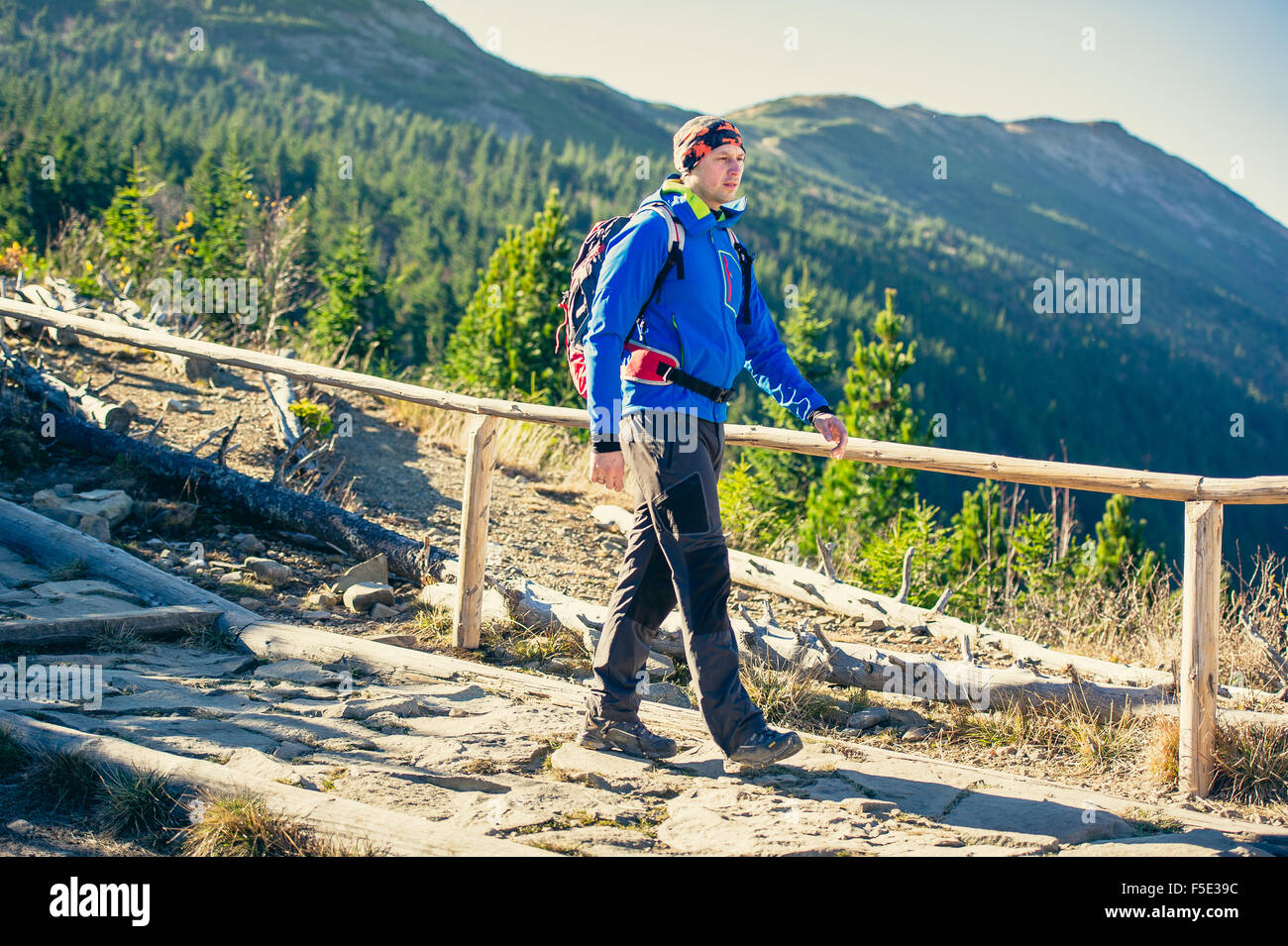 Man hiker trekking in mountains Stock Photo - Alamy