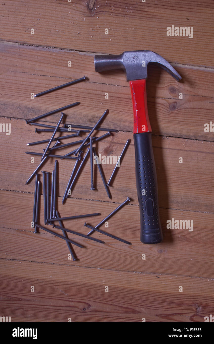 Hammer and nails lying on the boards Stock Photo - Alamy
