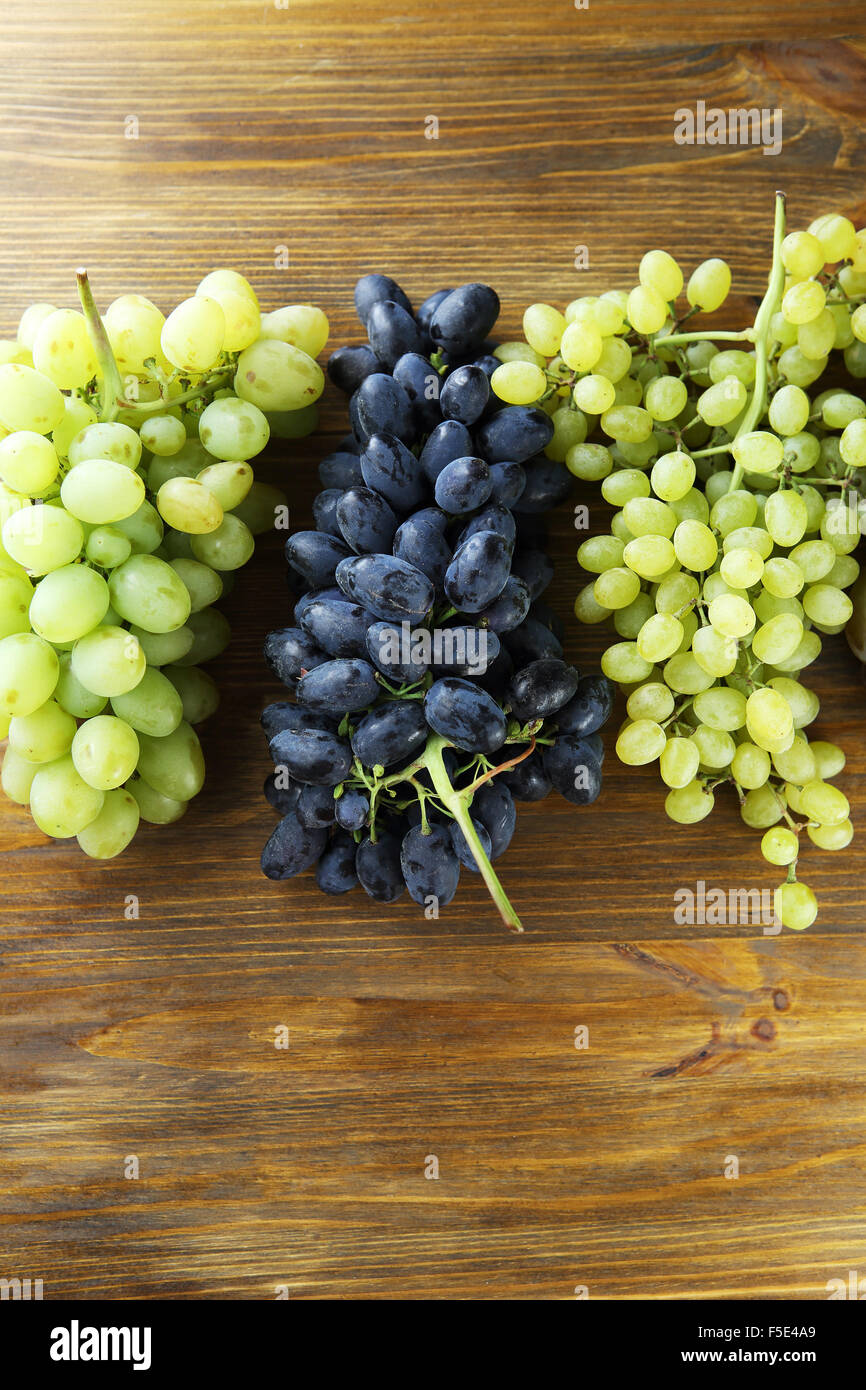 mix of fresh grapes on wooden background Stock Photo - Alamy