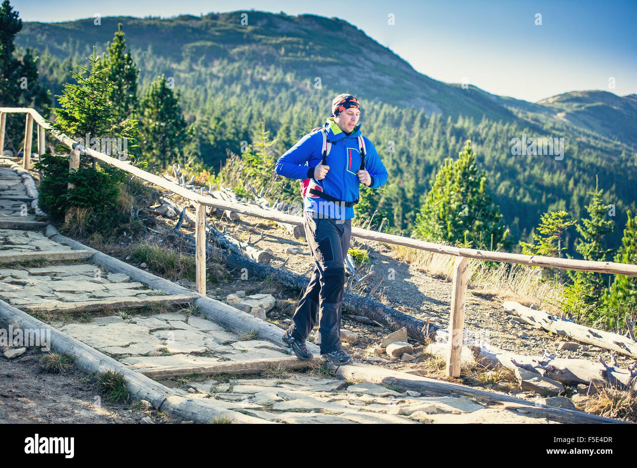 Man hiker trekking in mountains Stock Photo - Alamy