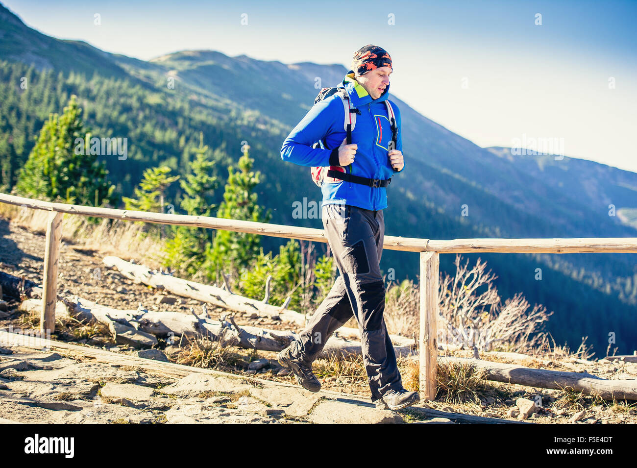 Man hiker trekking in mountains Stock Photo - Alamy