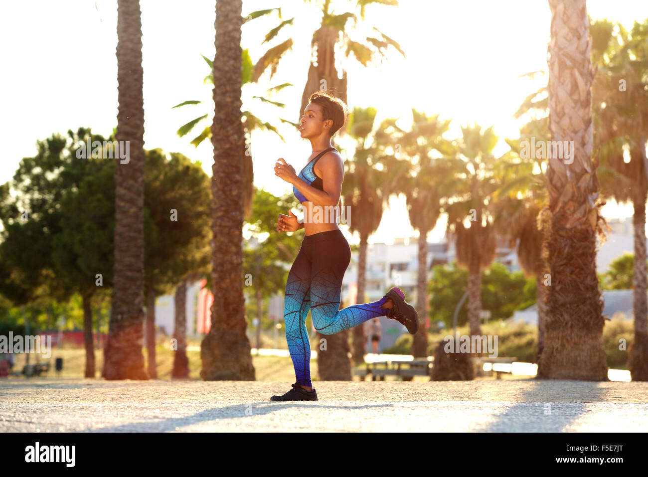 Full length side portrait of a young female runner Stock Photo - Alamy