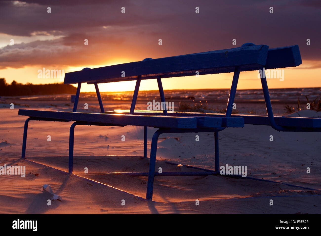 Bench at the beach in sunset time Stock Photo - Alamy