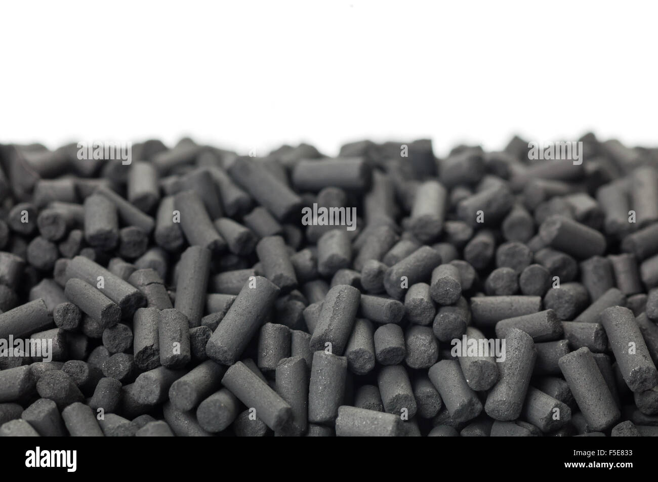 Activated carbon granules on white background Stock Photo - Alamy