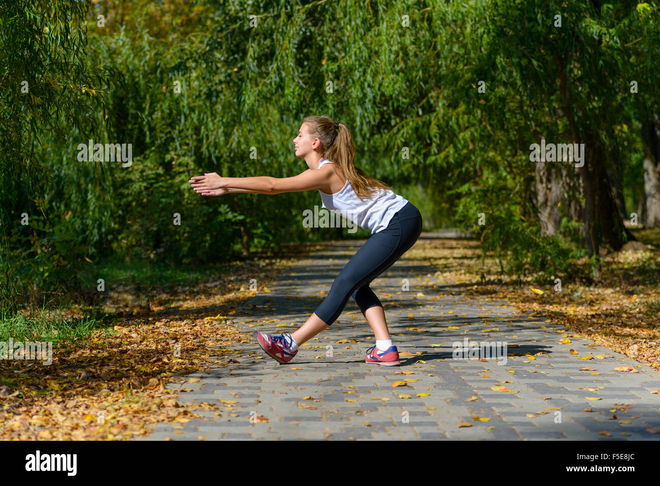 Attractive Woman stretching outdoor Stock Photo - Alamy