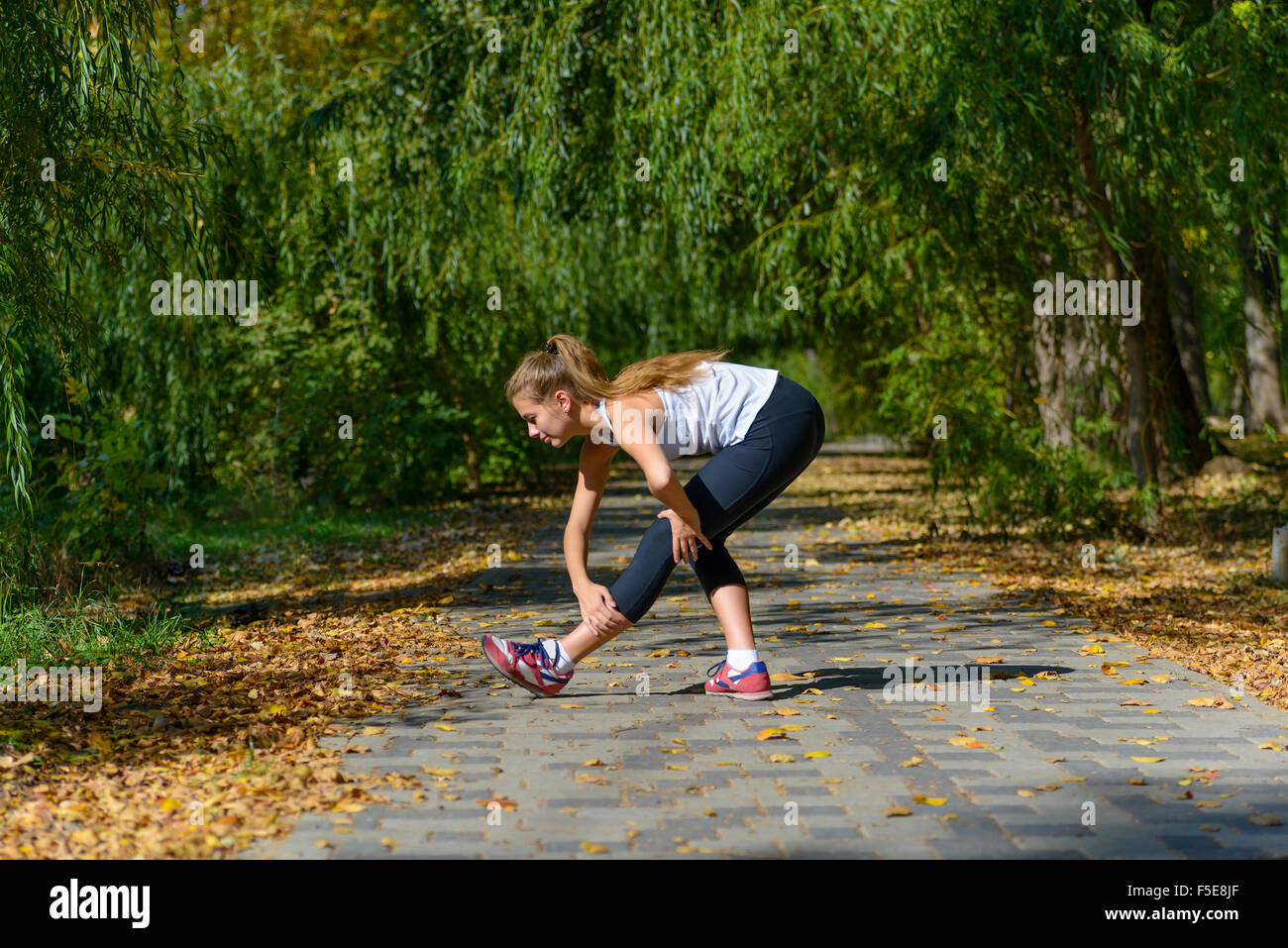 Attractive Woman stretching outdoor Stock Photo - Alamy