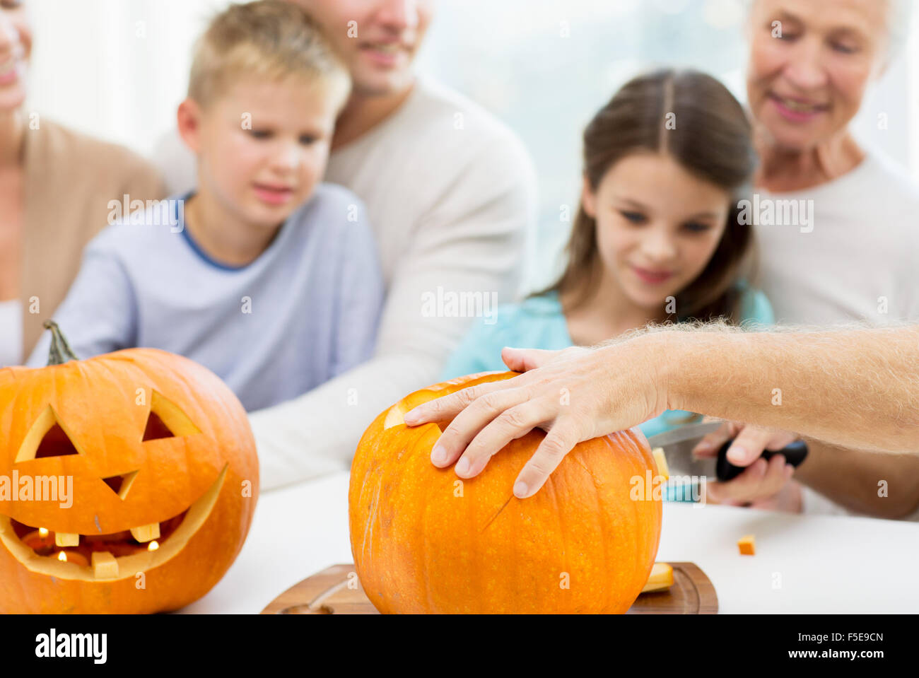 family making lantern of pumpkins for helloween Stock Photo - Alamy