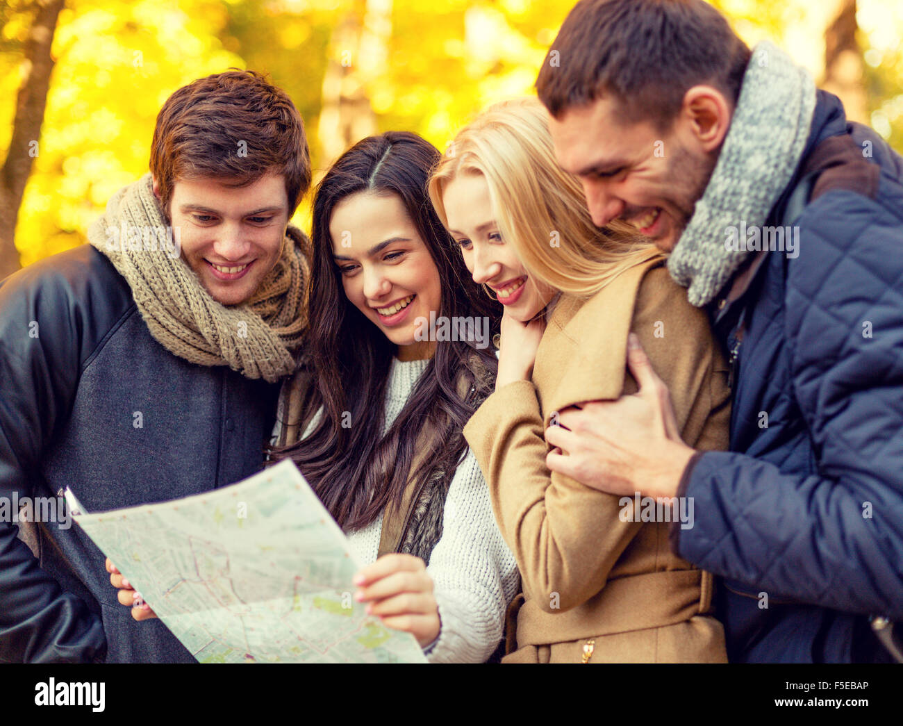 group of friends with map outdoors Stock Photo - Alamy