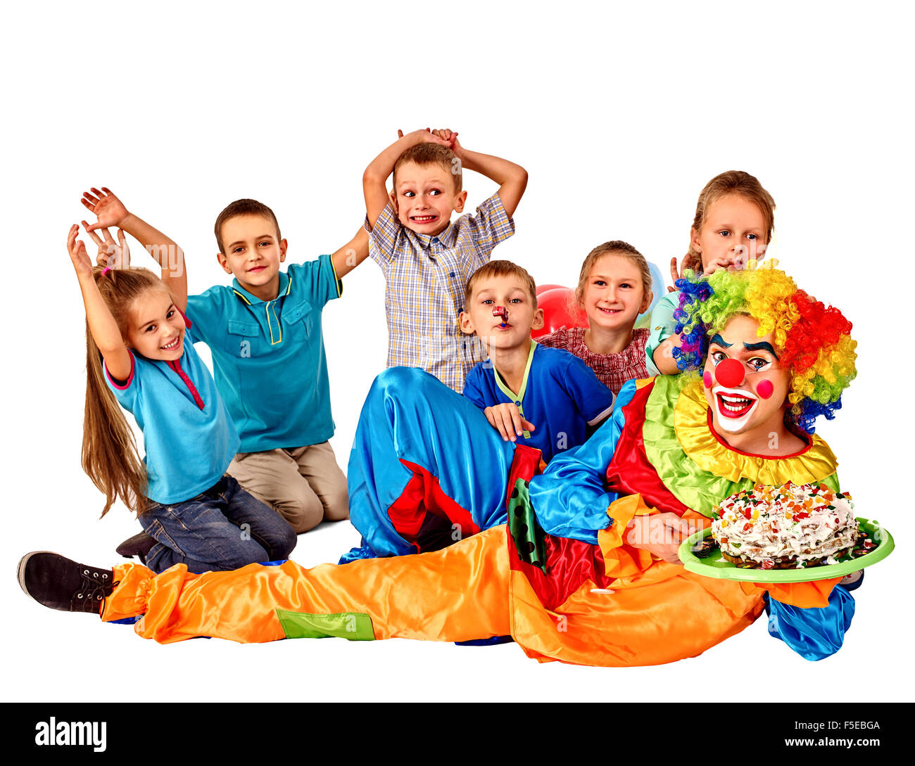 Clown holding cake on birthday with group happy kids Stock Photo - Alamy