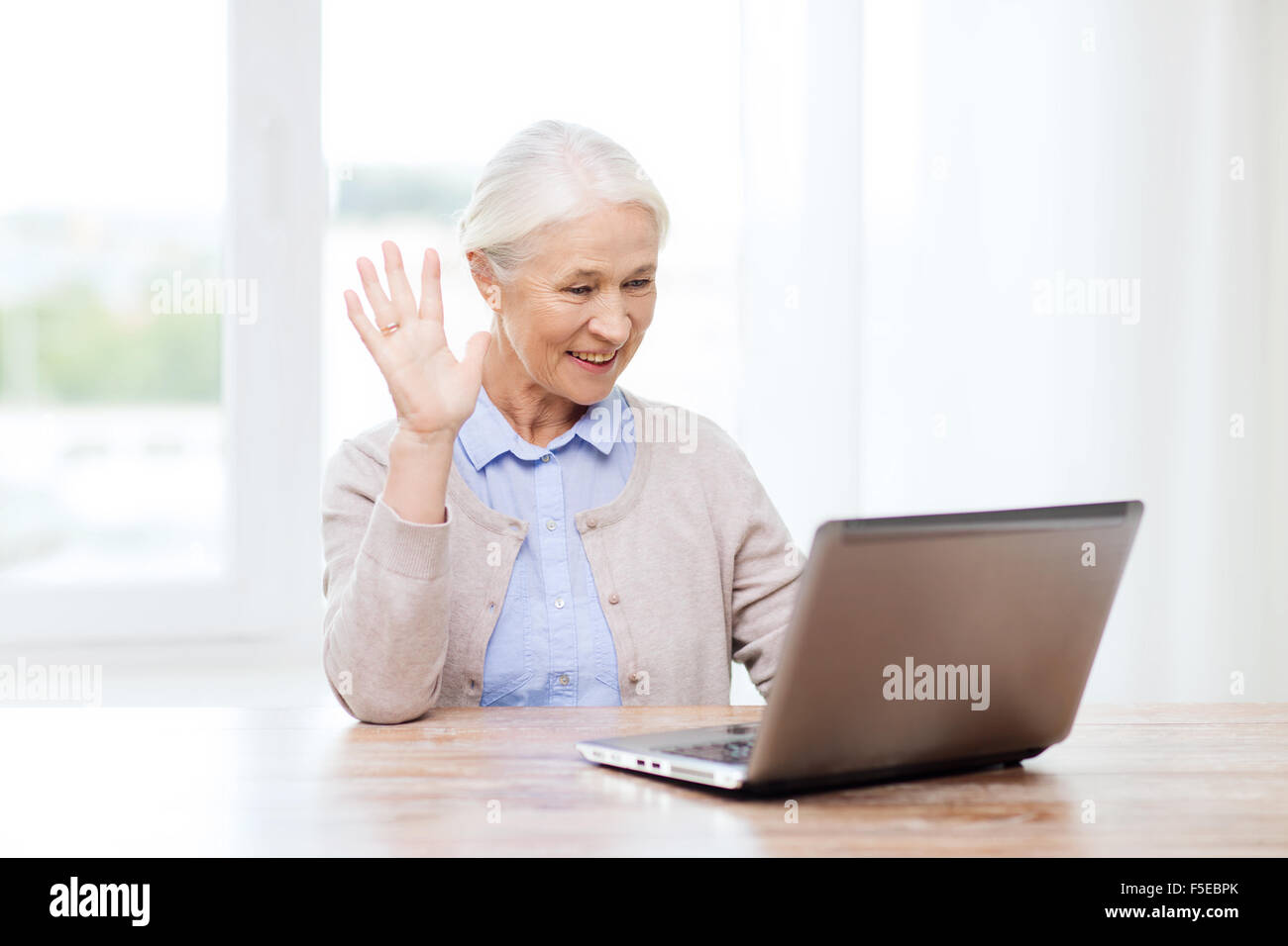 senior woman with laptop having video chat at home Stock Photo - Alamy