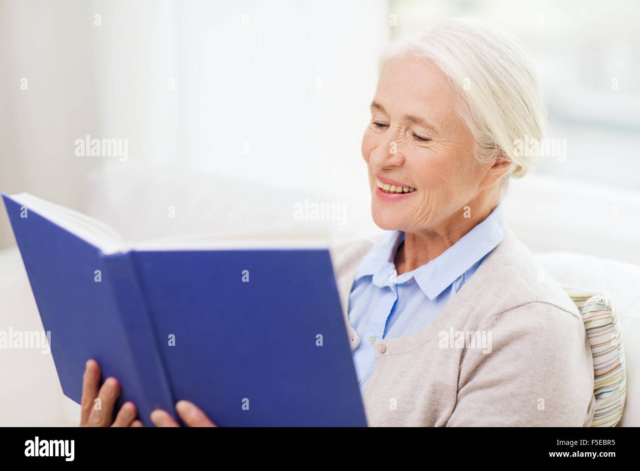 happy smiling senior woman reading book at home Stock Photo - Alamy
