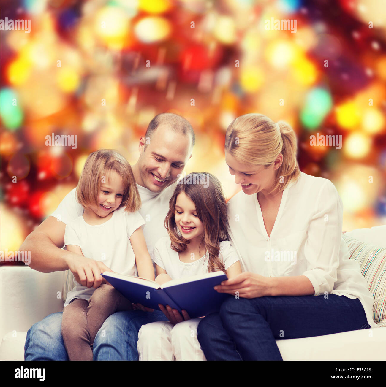 happy family with book at home Stock Photo - Alamy