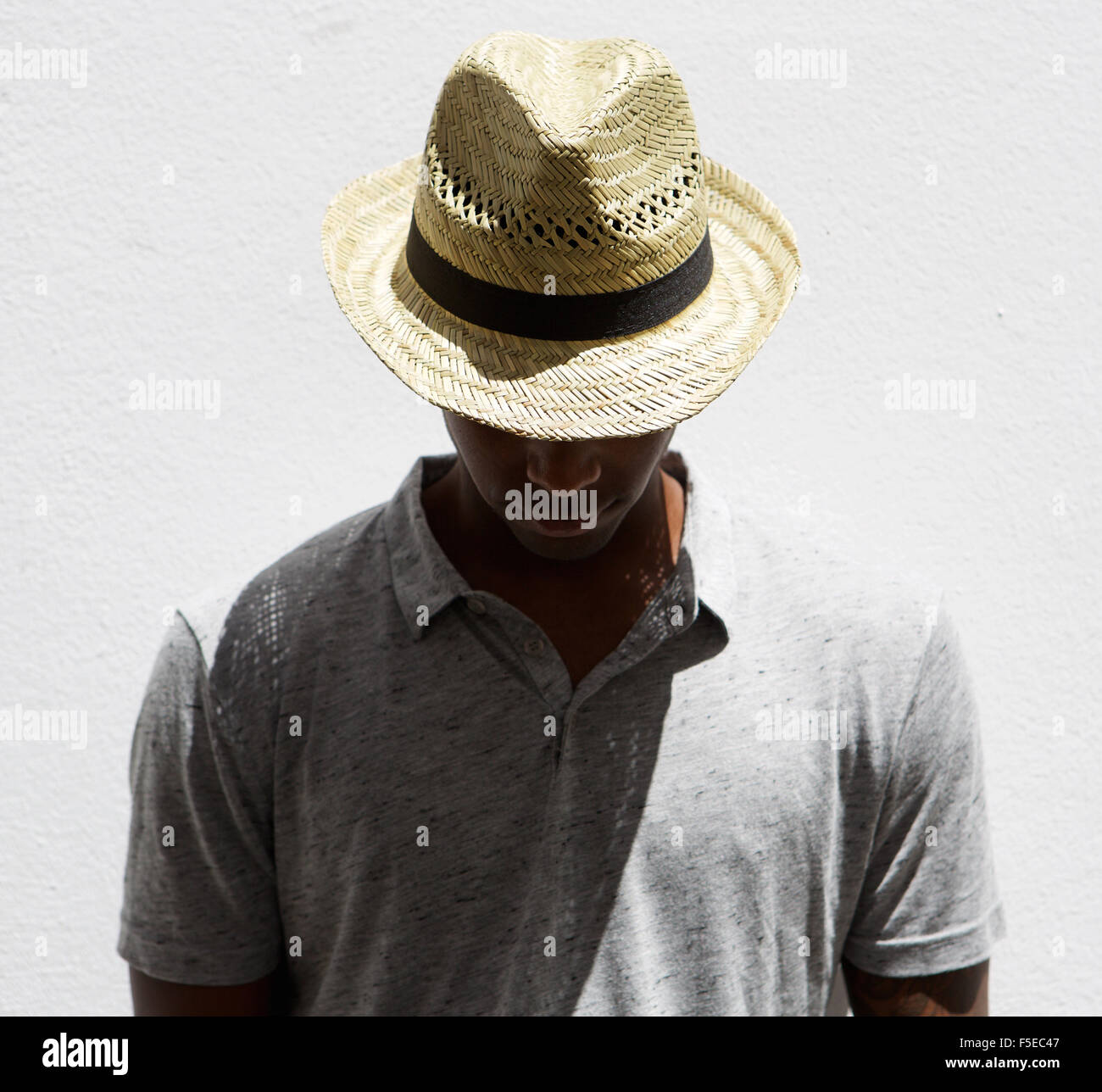 Close up portrait of a male fashion model with hat looking down Stock ...