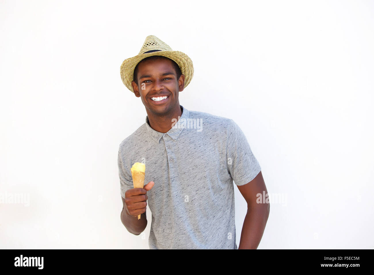 Close up portrait of a handsome young man enjoying ice cream cone Stock ...