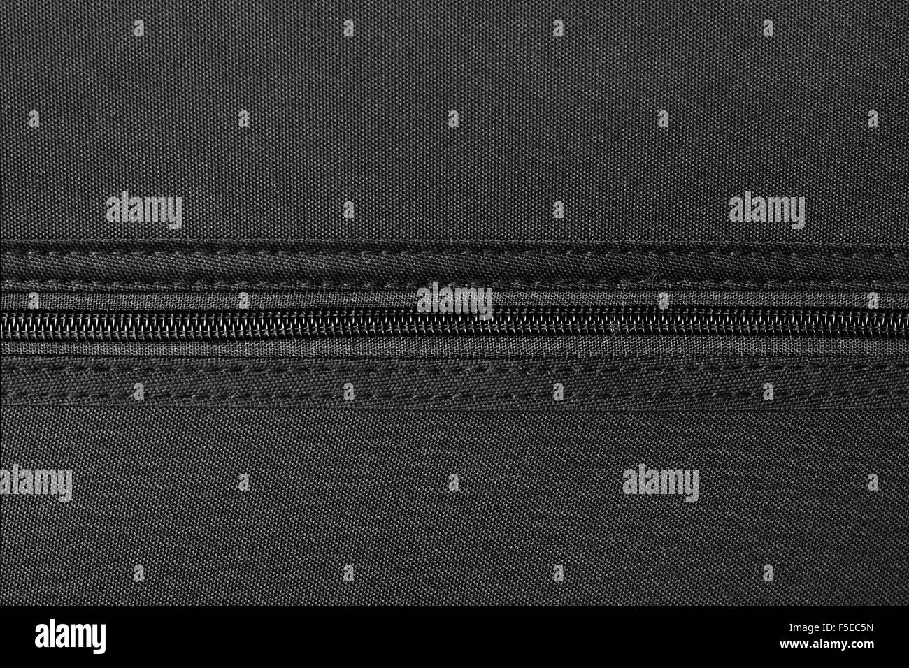 zipper on black material fabric Stock Photo - Alamy