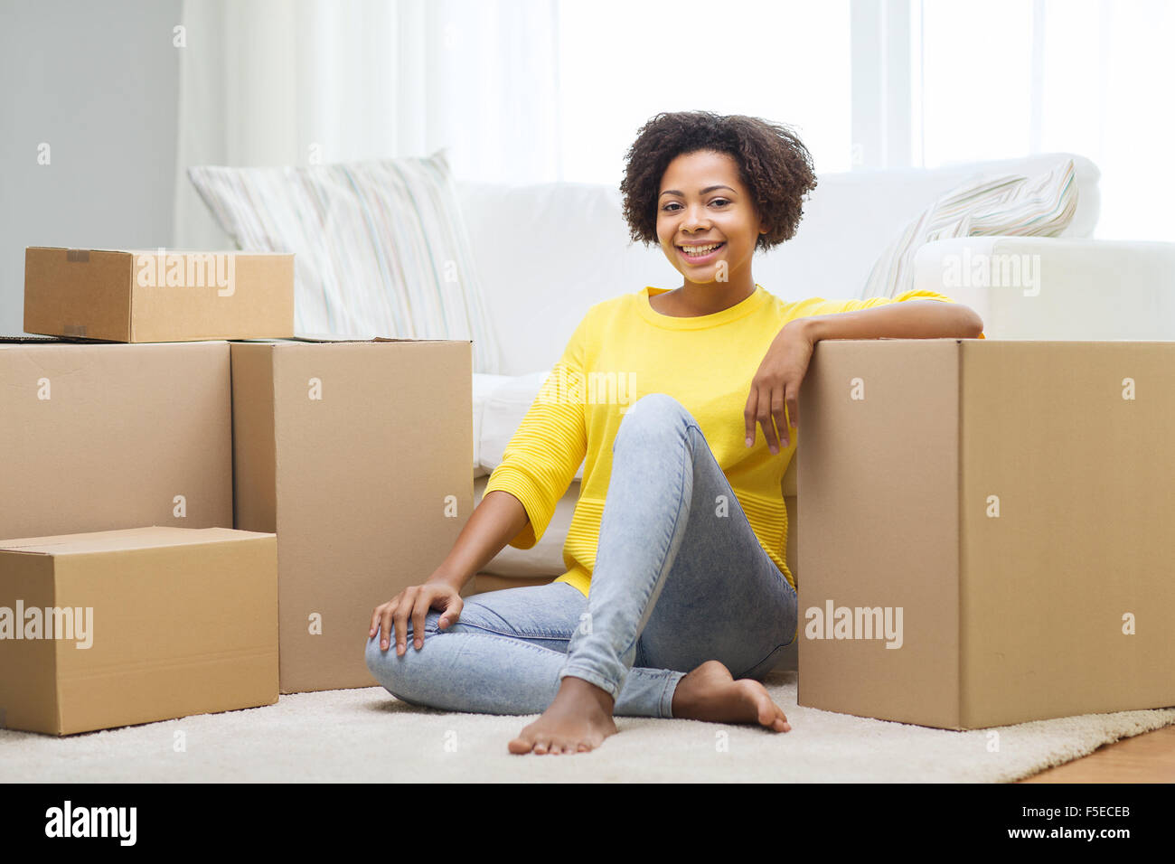 happy african woman with cardboard boxes at home Stock Photo - Alamy