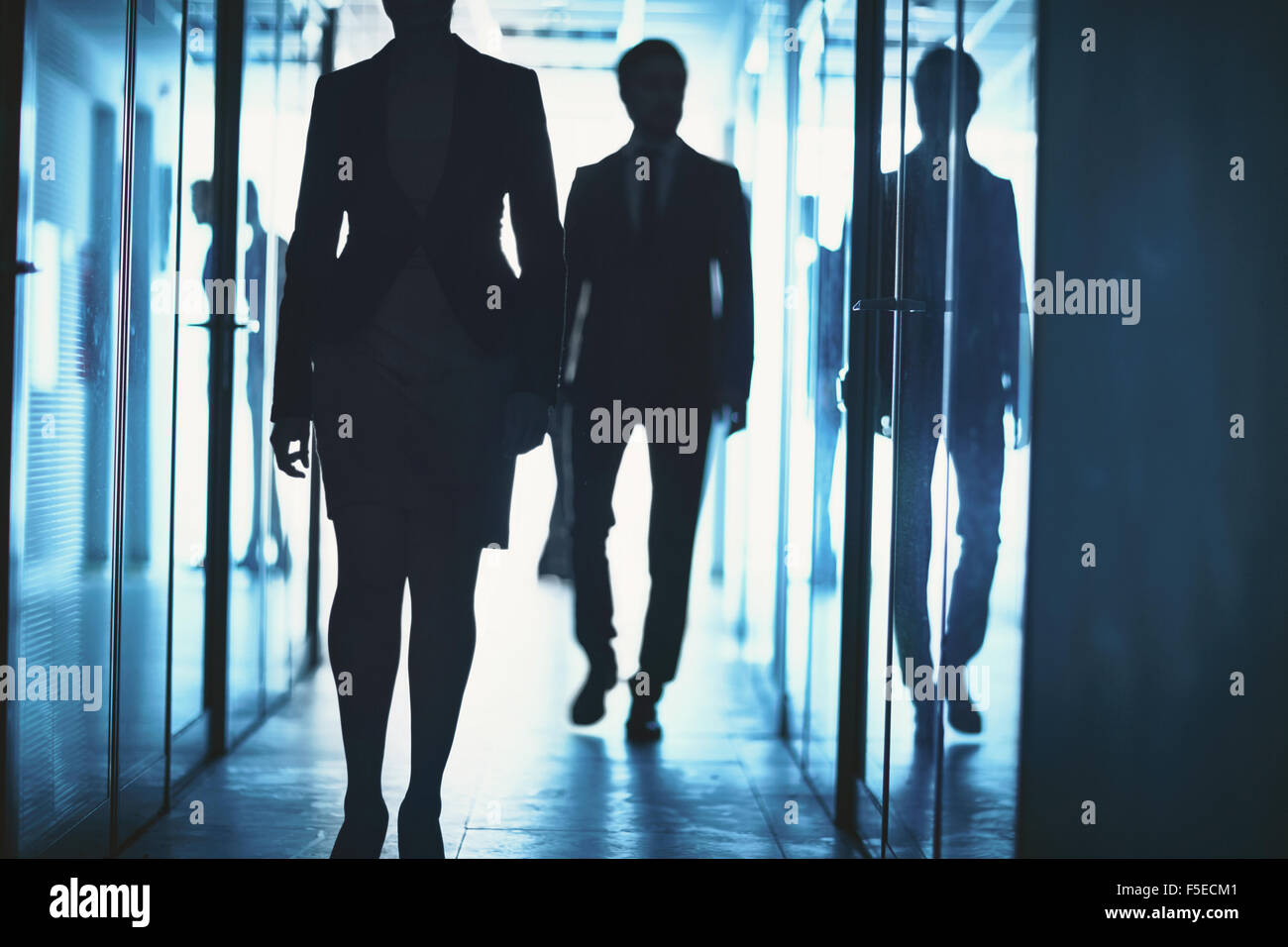 Office workers walking down corridor of business center Stock Photo - Alamy