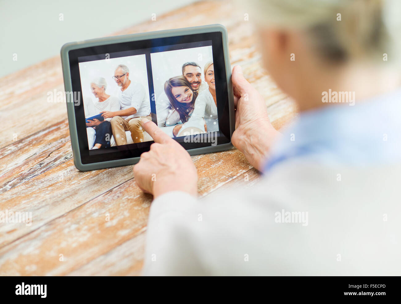 senior woman with family photo on tablet pc screen Stock Photo - Alamy