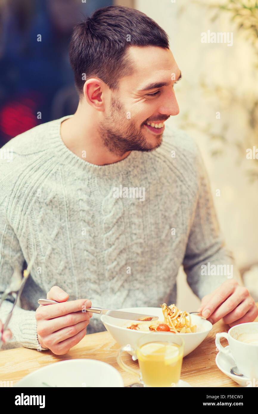 happy young man having dinner at restaurant Stock Photo - Alamy