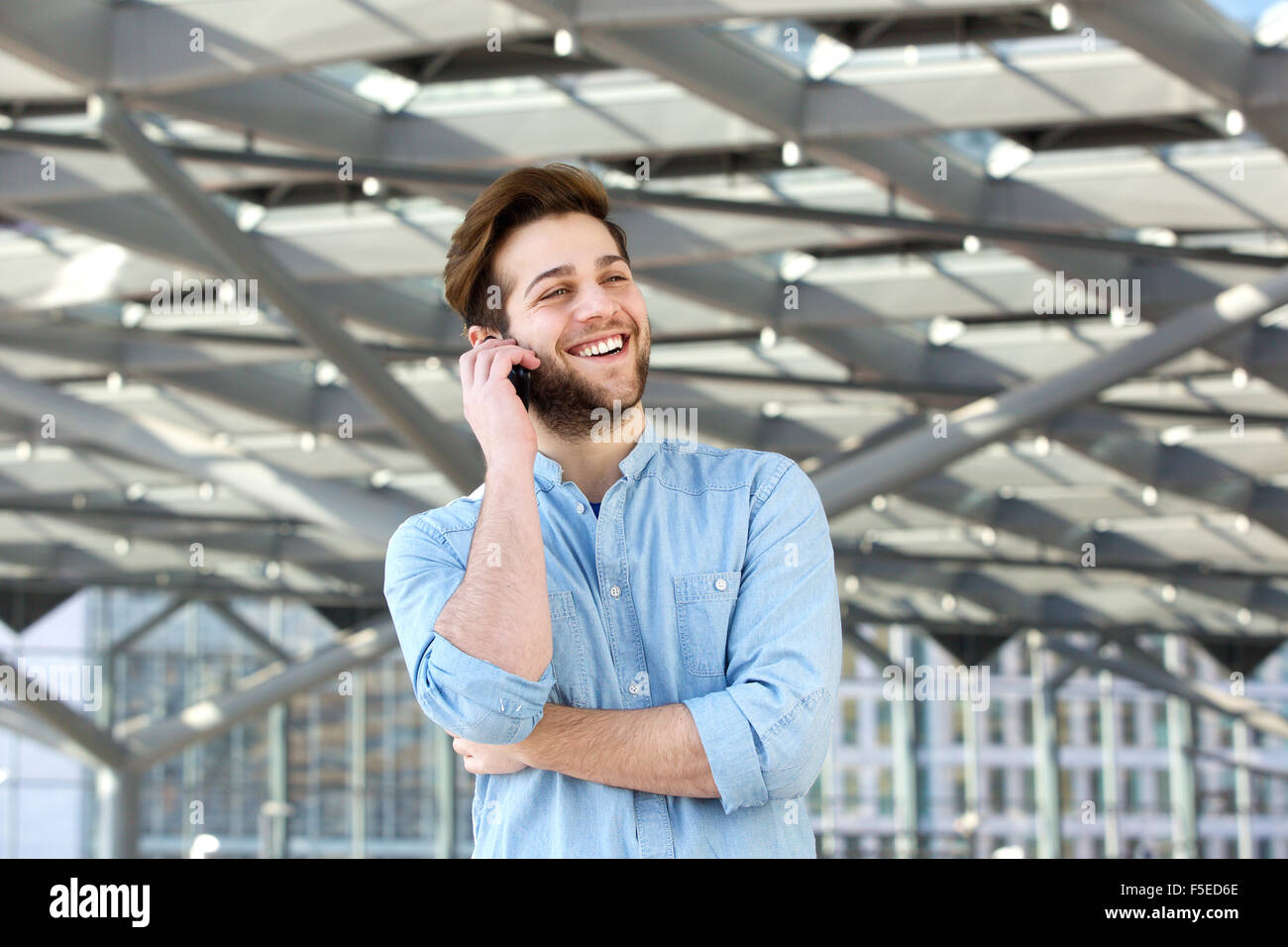 Portrait of a happy cool guy talking on mobile phone Stock Photo - Alamy