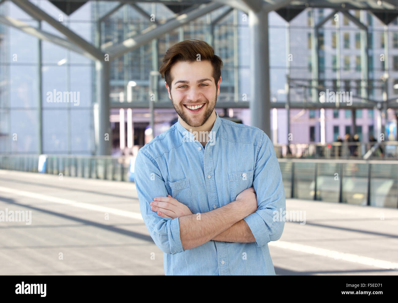 Close up portrait of a cool guy smiling with arms crossed Stock Photo ...