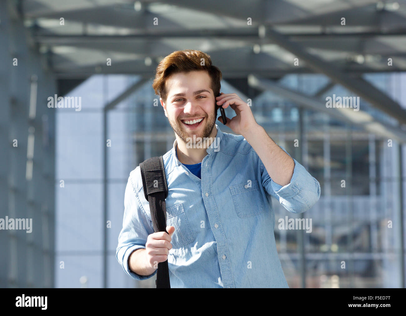 Young man cell phone airport hi-res stock photography and images - Alamy