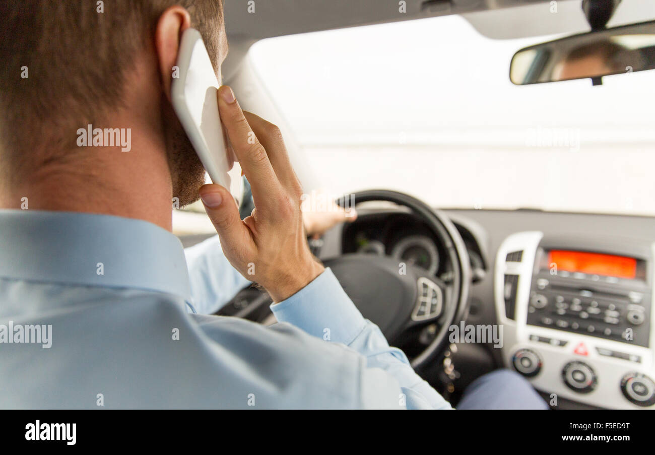 close up of man with smartphone driving car Stock Photo - Alamy