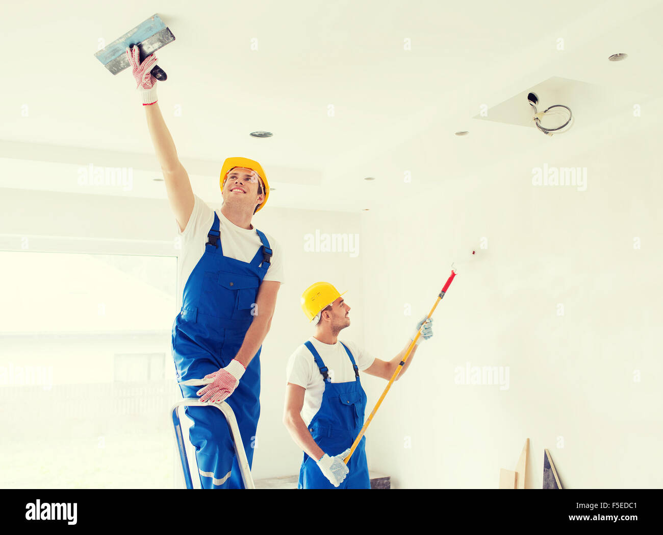 group of builders with tools indoors Stock Photo - Alamy