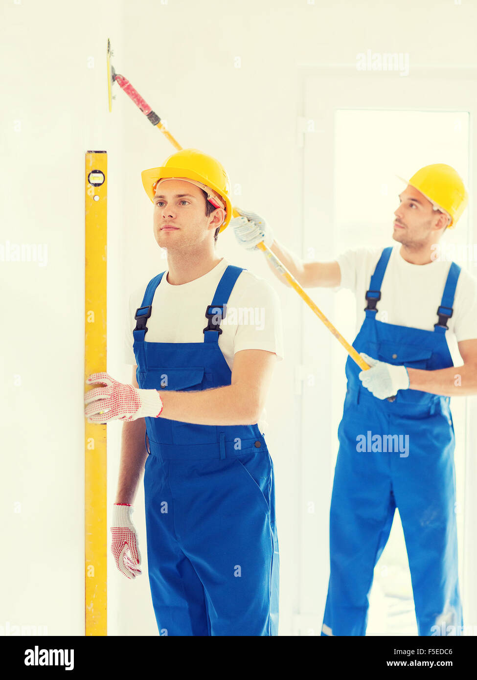 group of builders with tools indoors Stock Photo - Alamy