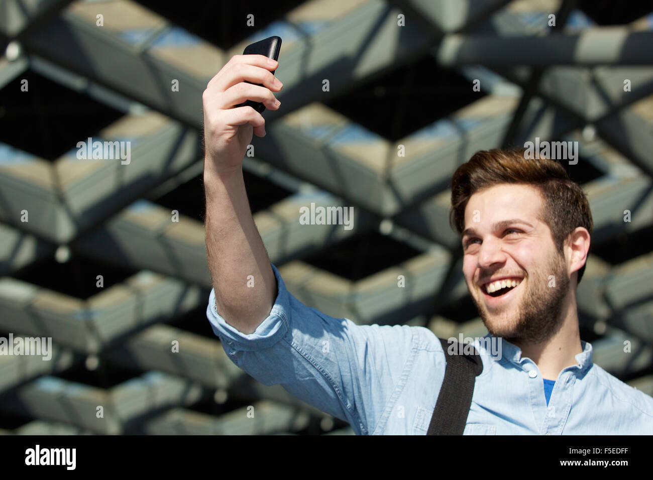 Portrait of a happy young modern man taking selfie Stock Photo - Alamy