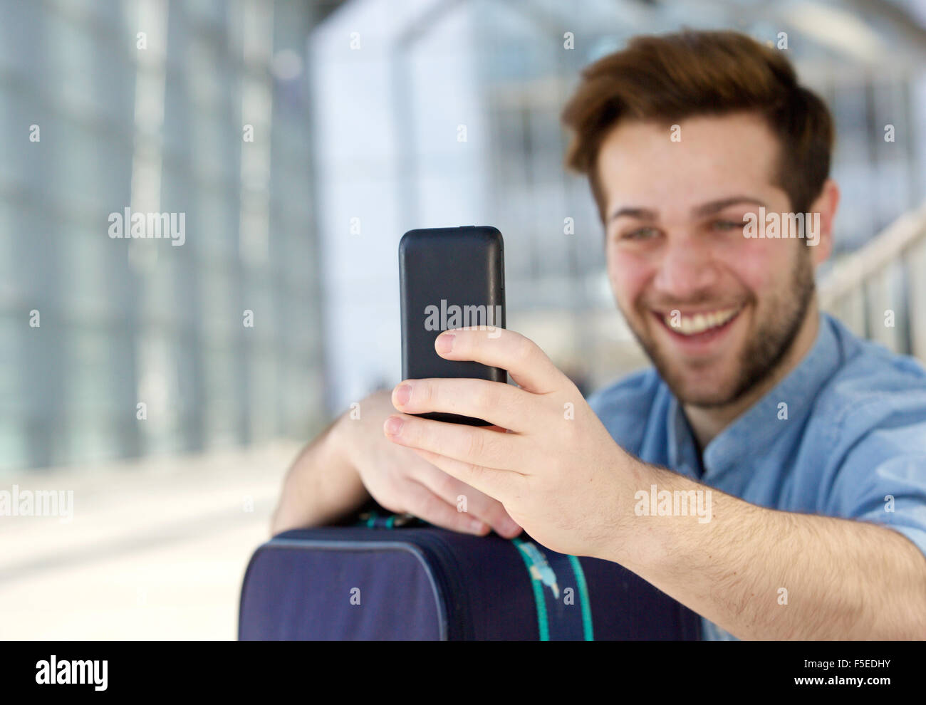 Close up portrait of a cool young guy taking selfie with mobile phone ...