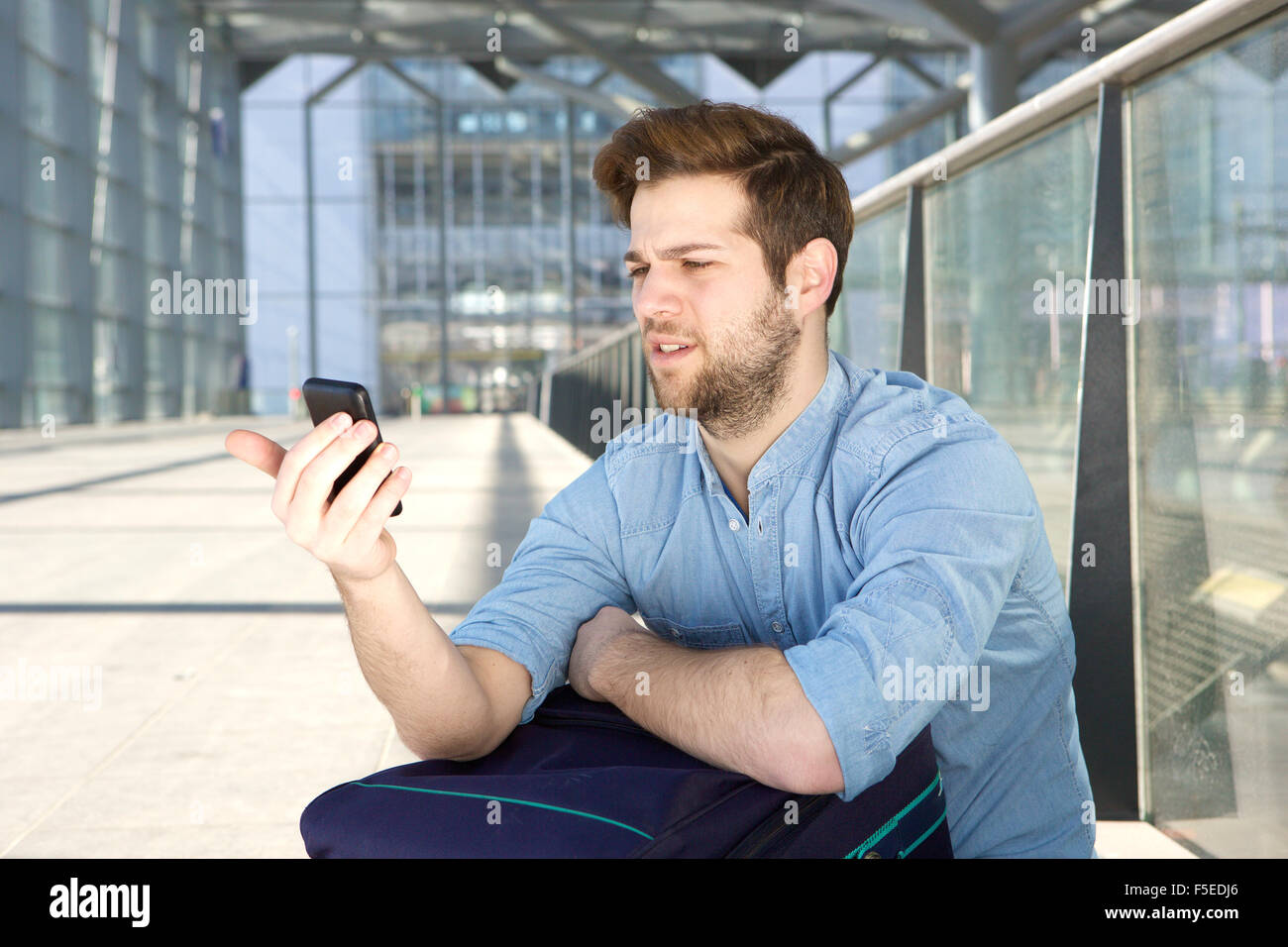 Young man looking confused reading hi-res stock photography and images ...