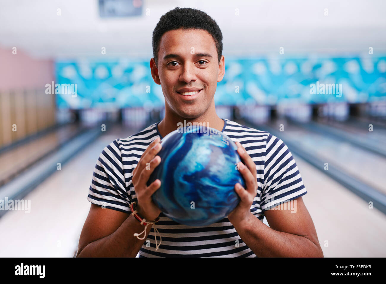Handsome young man with bowling ball Stock Photo - Alamy