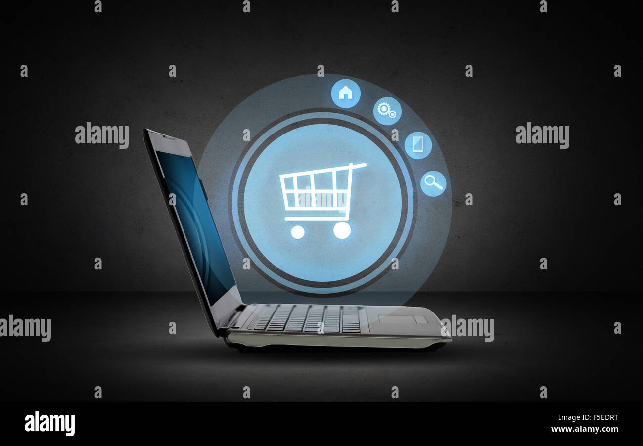 laptop computer with shopping cart icon projection Stock Photo - Alamy