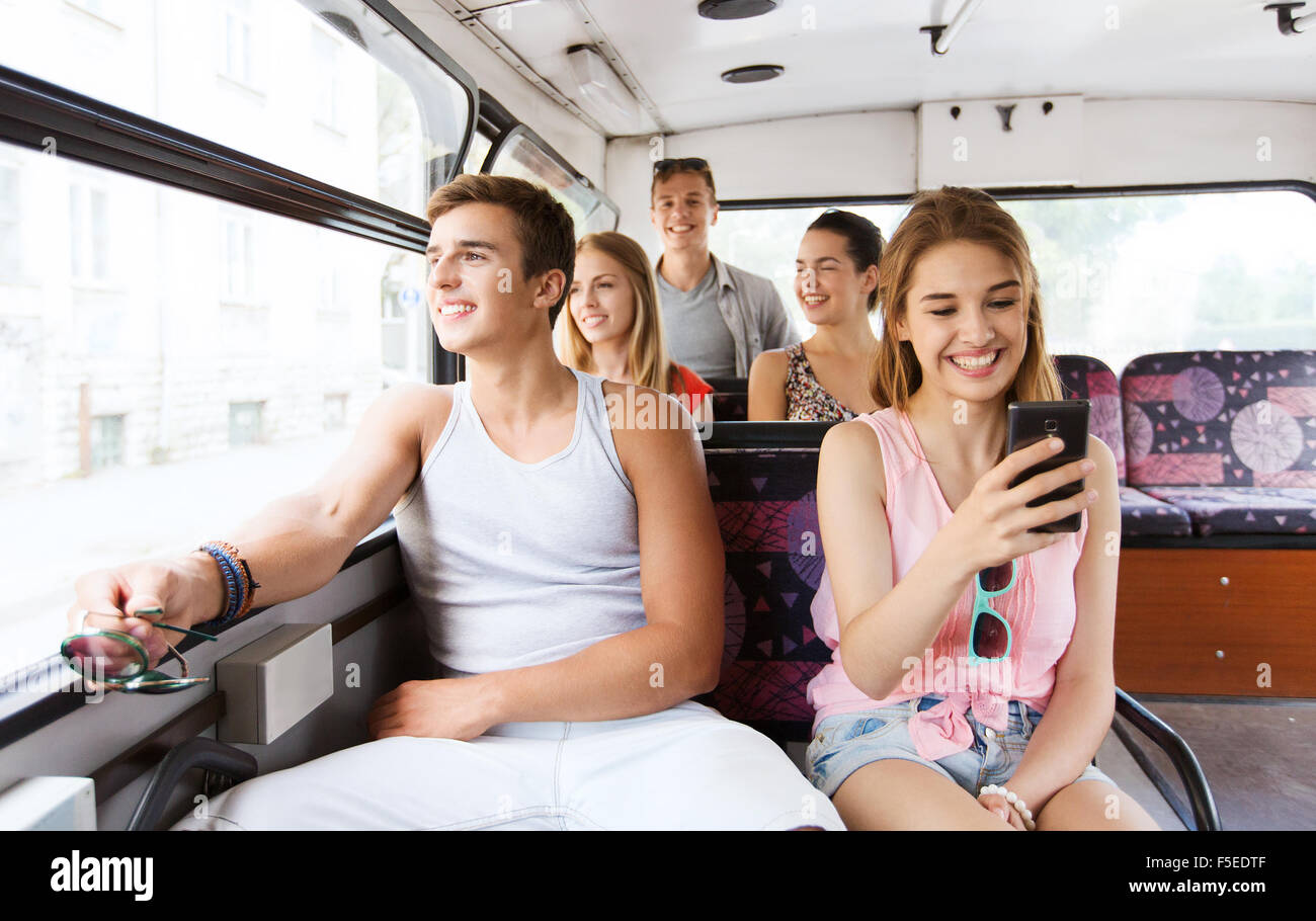 happy teenage friends traveling by bus Stock Photo - Alamy