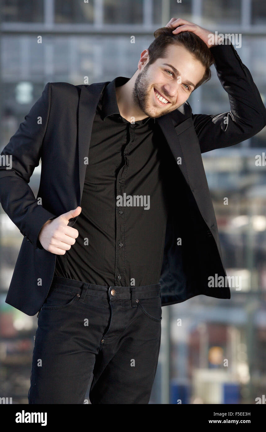 Portrait of a male fashion model smiling with hand in hair Stock Photo ...